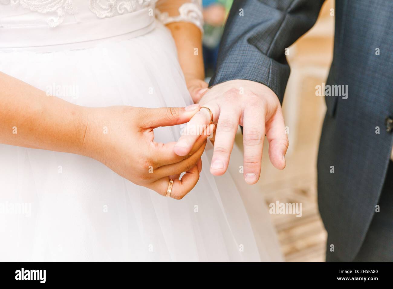 Bride and groom marriage hands with wedding rings. Bride hand putting ...