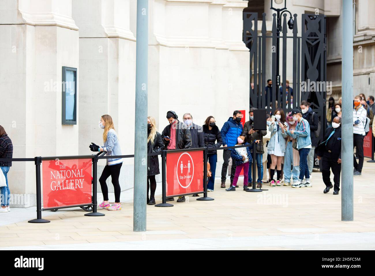 People queue outside the National Gallery in London as indoor venues ...