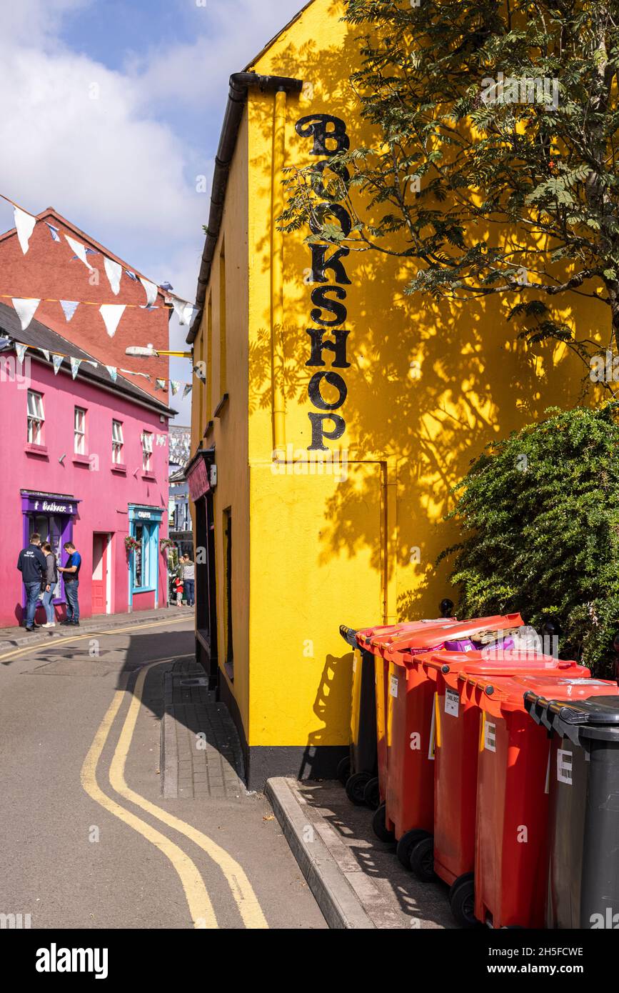Colourful Street scene on a summer morning in Kinsale, red rubbish bins ...