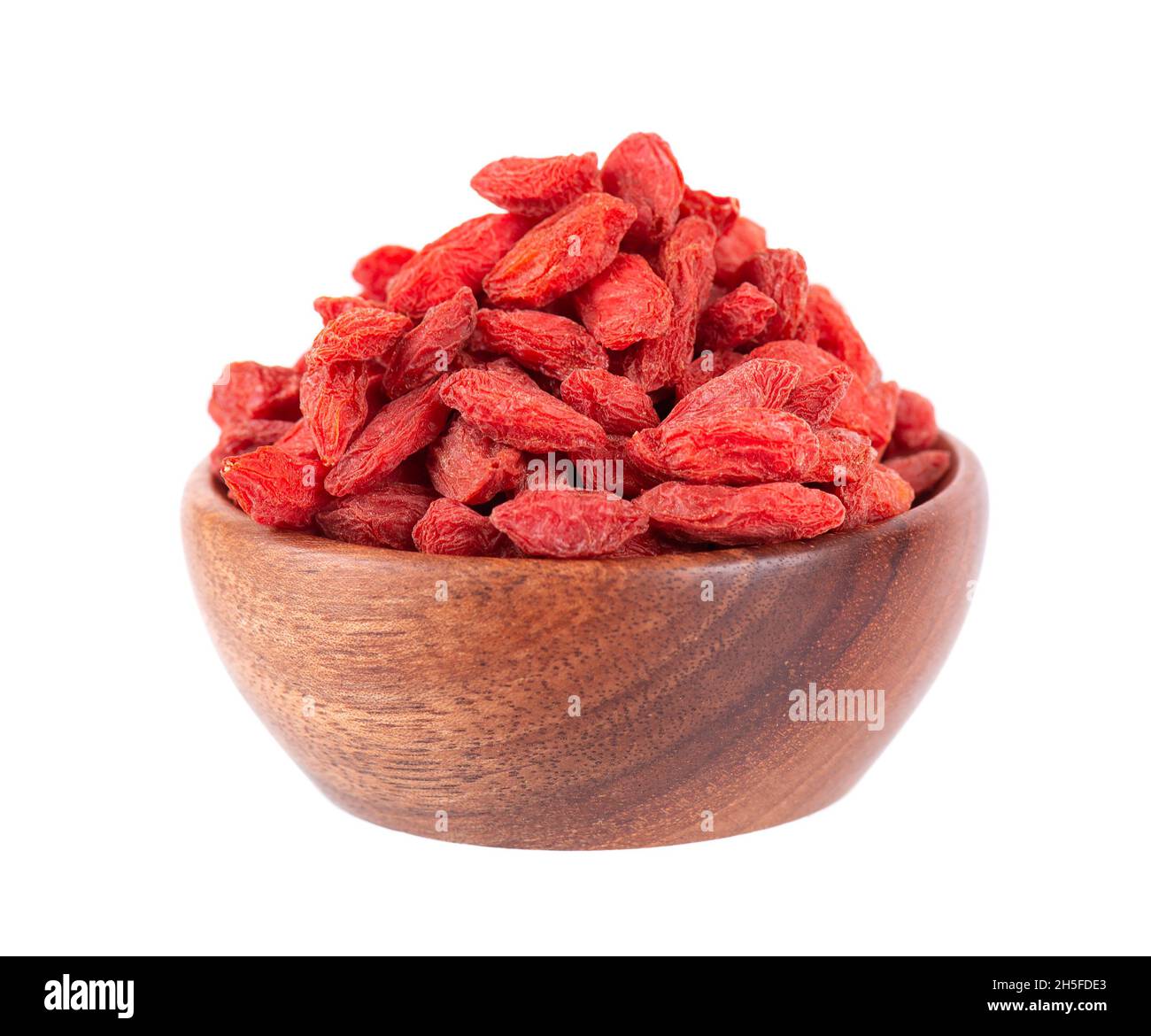 Chinese wolfberries in wooden bowl, isolated on white background. Heap ...