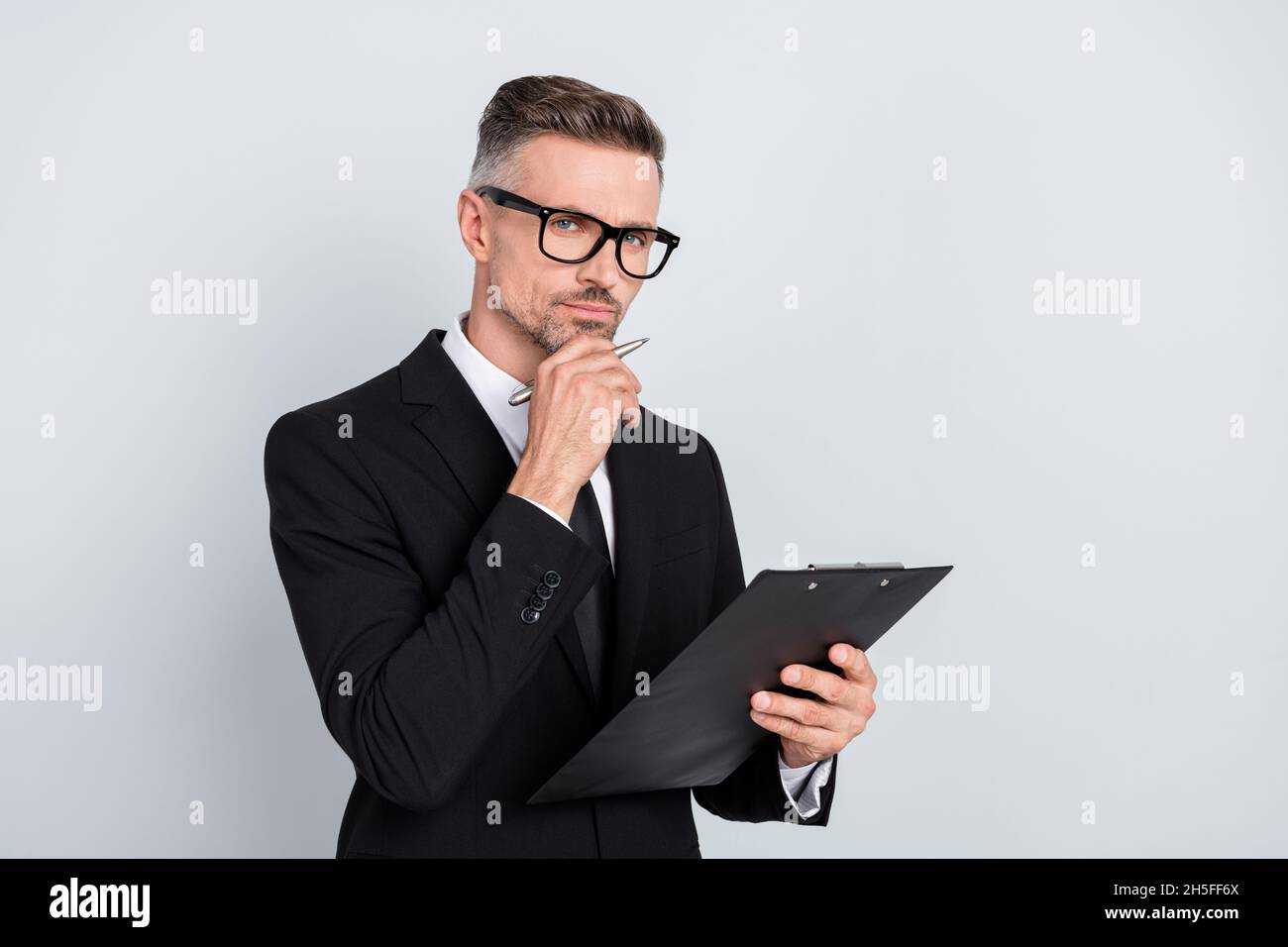 Photo of stylish minded attorney guy hold check-list think start-up ...