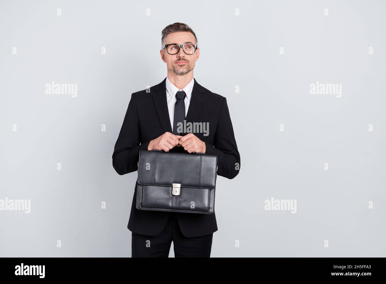 Photo of minded leader marketer guy hold briefcase look empty space ...