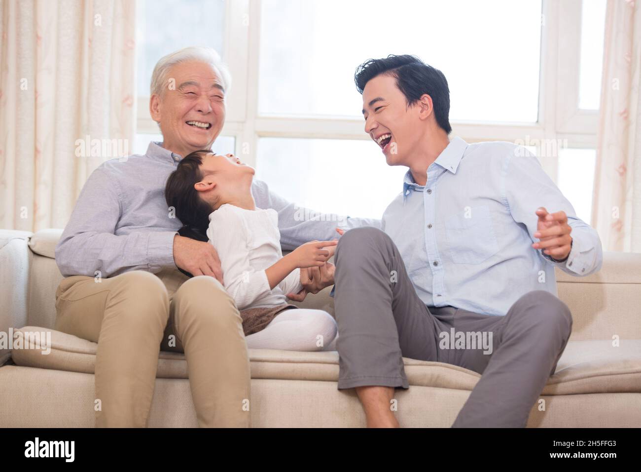 Three generations of a happy family Stock Photo - Alamy