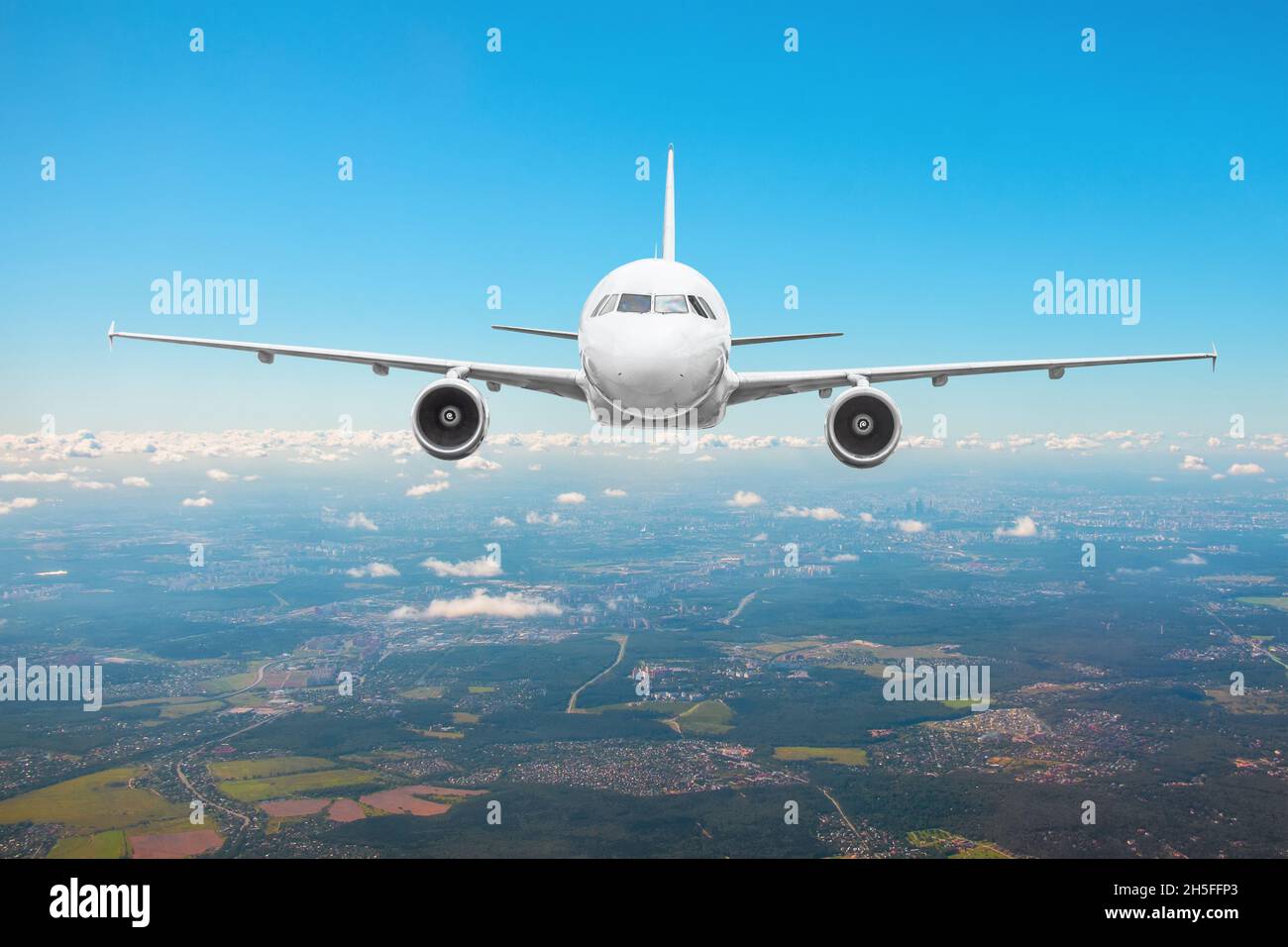 Airplane flies over the city town exactly in the center, a view of the ...