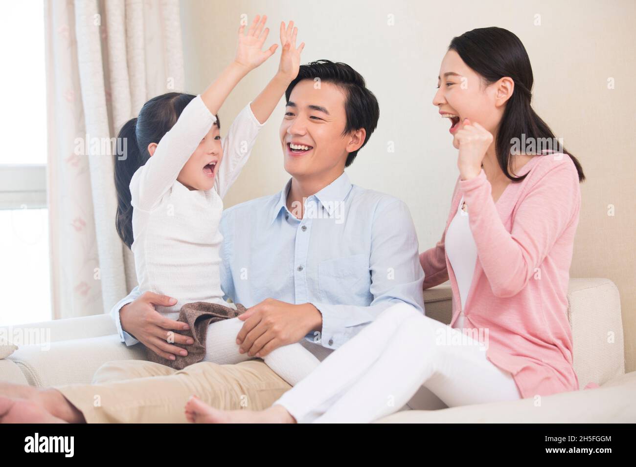 Happy and loving family of three Stock Photo - Alamy