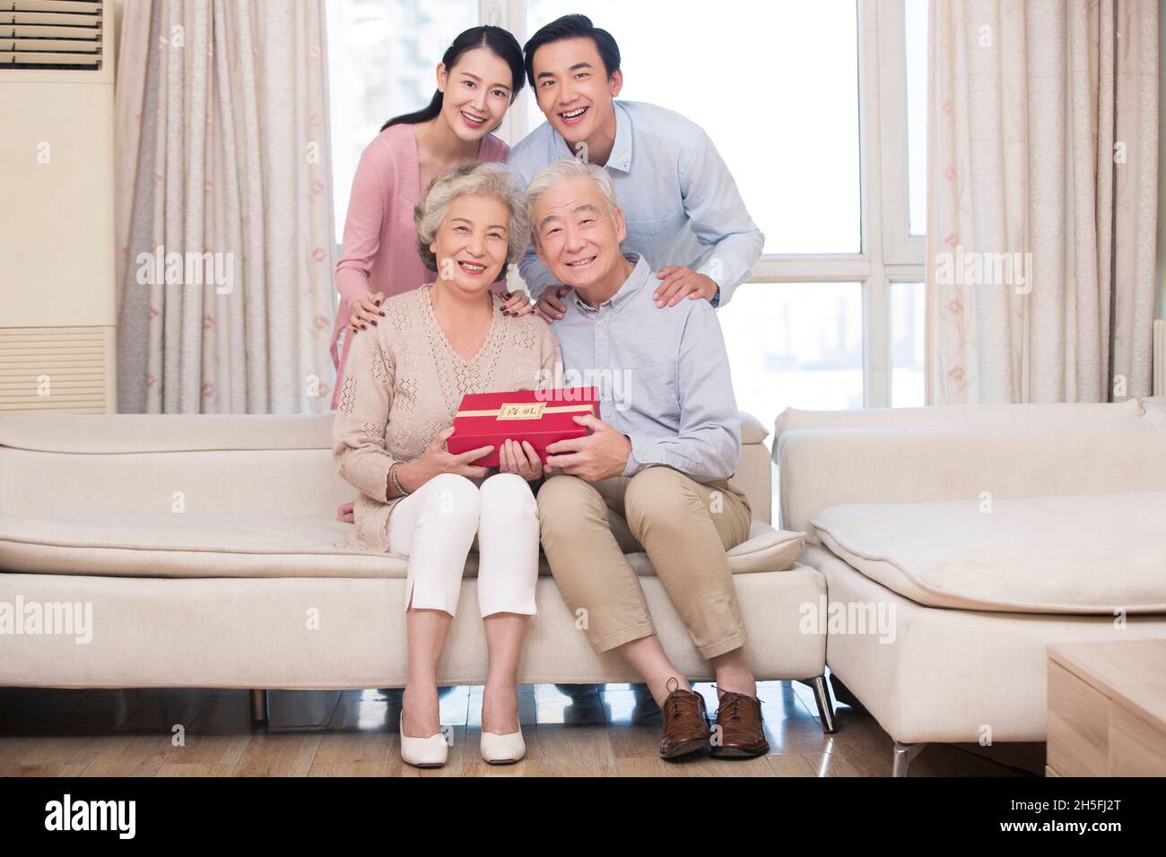 Happy family and their presents Stock Photo - Alamy