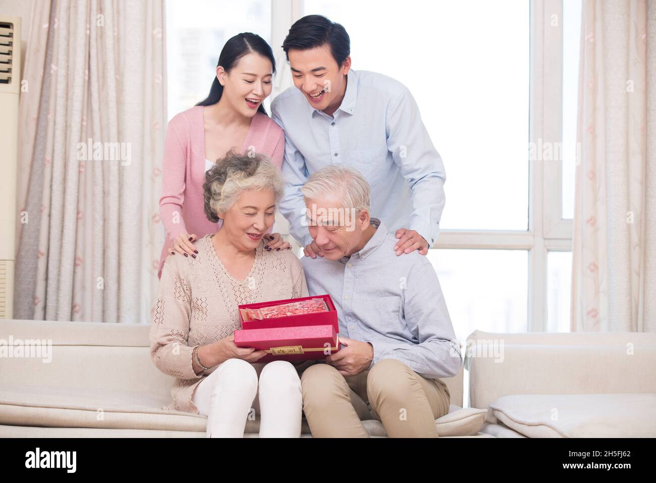 Happy family and their presents Stock Photo - Alamy