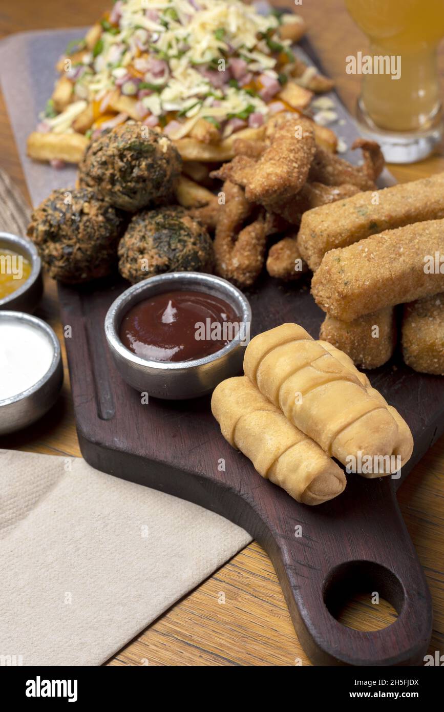 Delicious fried sticks, white sauce, mozzarella sticks, and a glass of ...