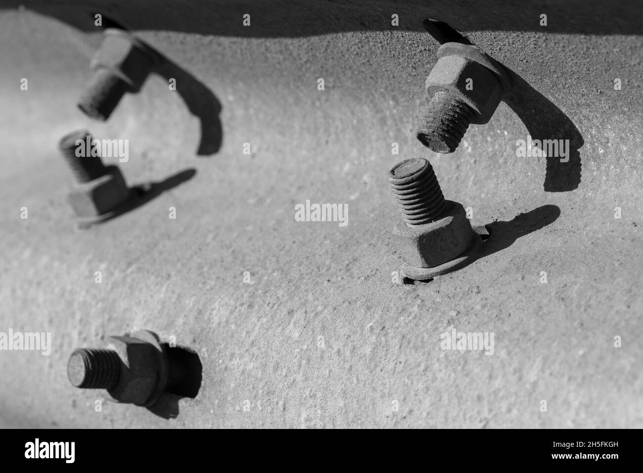 Abstract industrial background with gray bolts and shadows, close-up ...