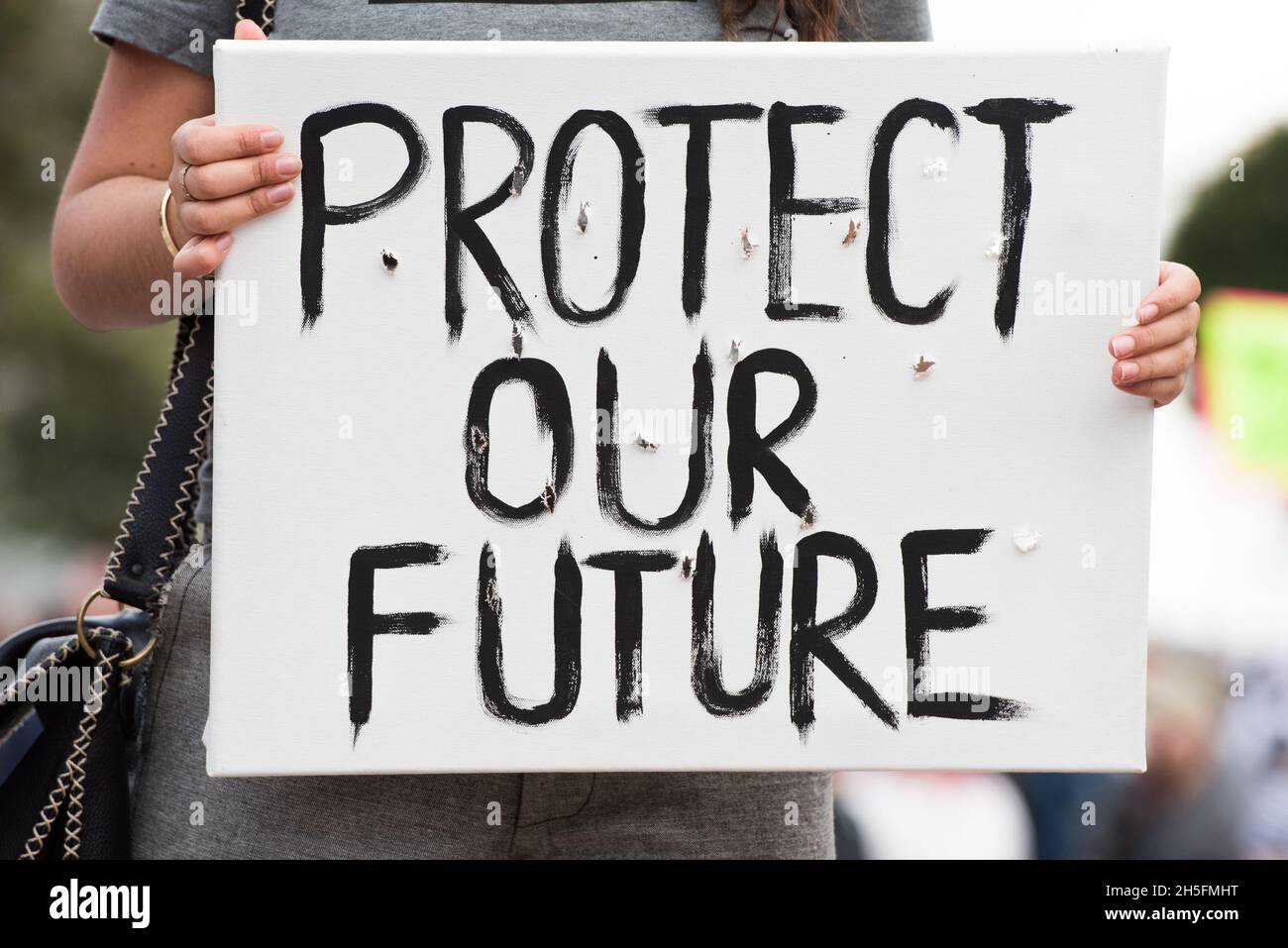 Woman Holding Sign Saying "Protect Our Future Stock Photo - Alamy