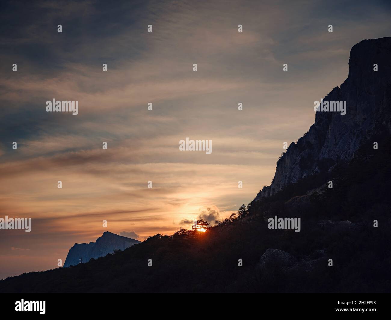 beautiful sunset in mountains, silhouettes of rocks and trees. Idea and ...