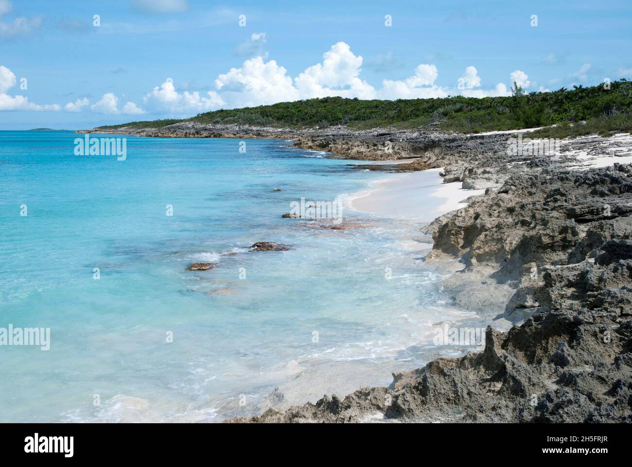 The scenic view of rocky shore and transparent waters on Half Moon Cay ...