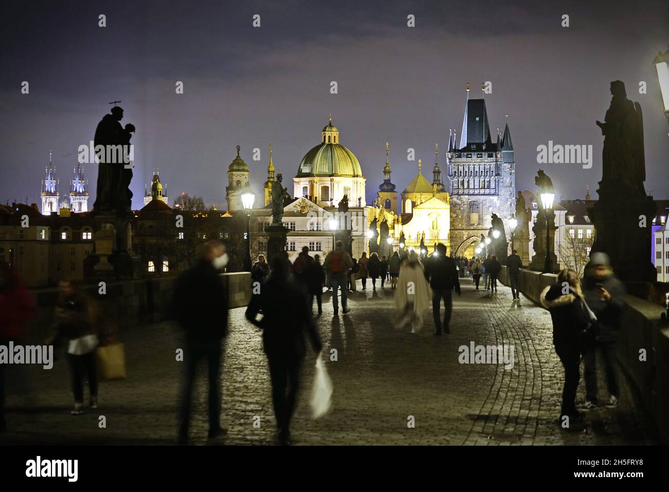 Charles Bridge by night is a popular tourist attraction in Prague ...