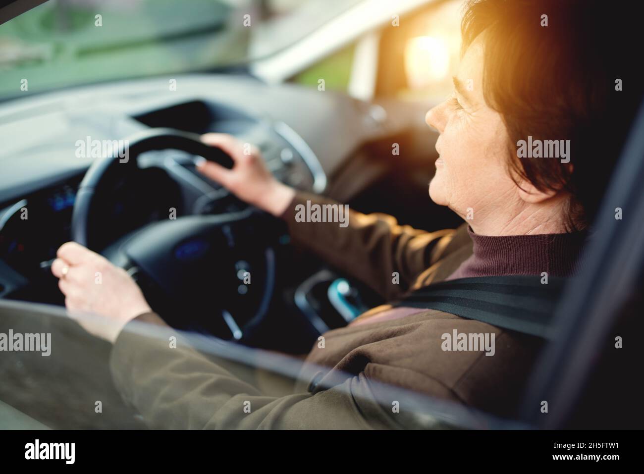 Old woman driving a car smiling enjoying the road trip Stock Photo - Alamy