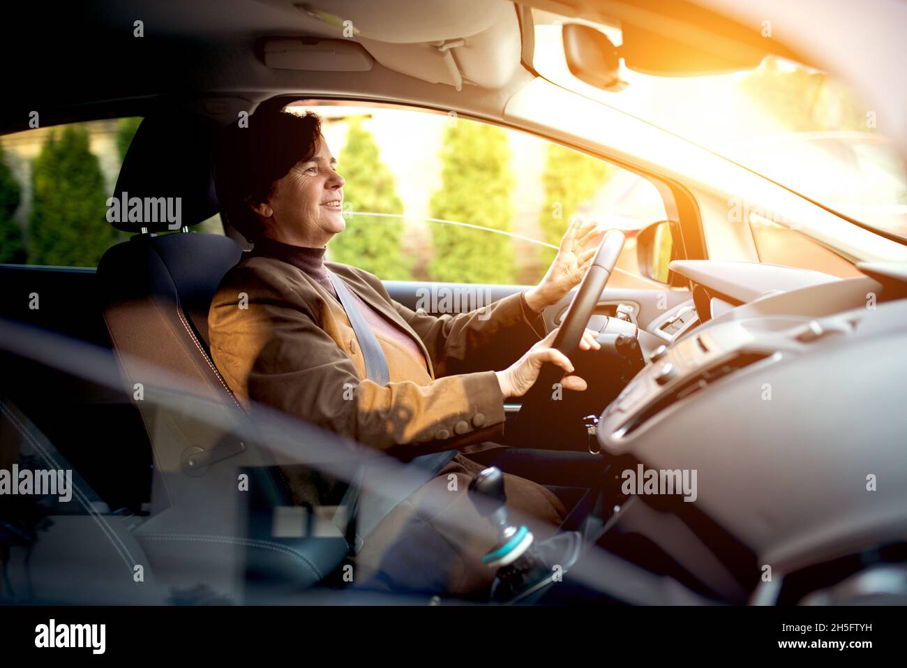 Middle aged woman driving a car Stock Photo - Alamy
