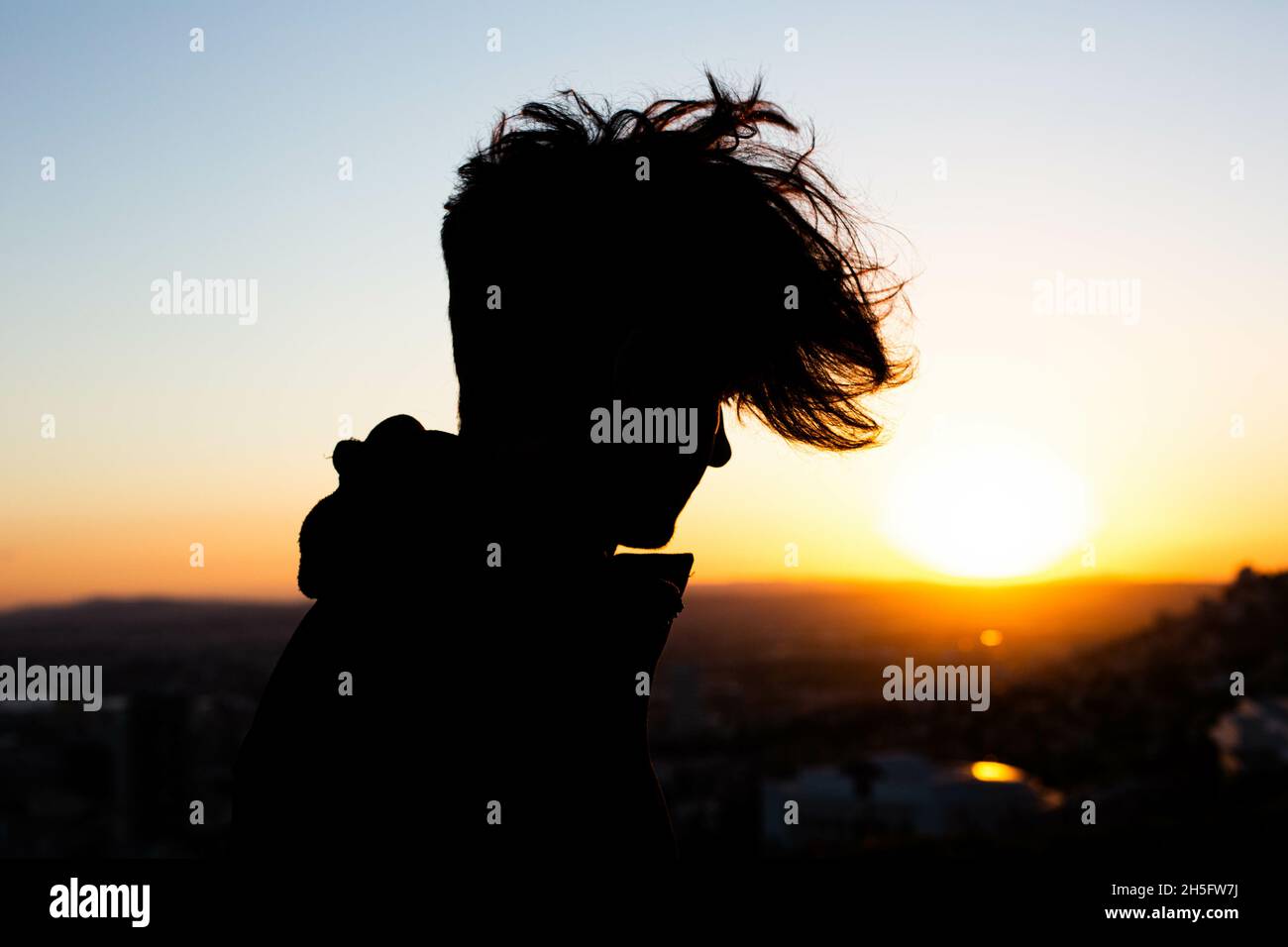 Side portrait silhouette of a female against the sunset sky Stock Photo ...