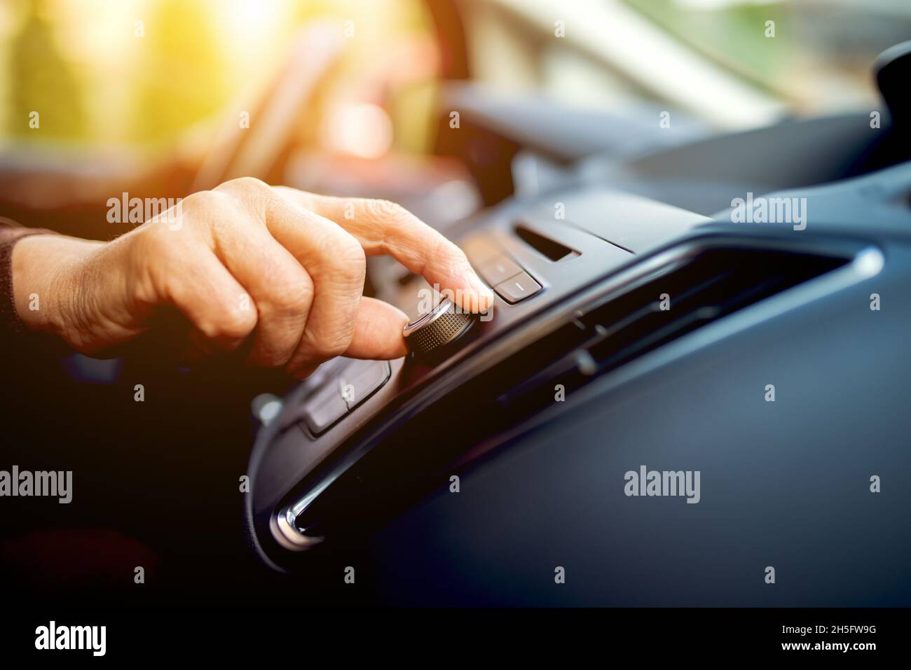 Turning on radio at car driving home Stock Photo - Alamy