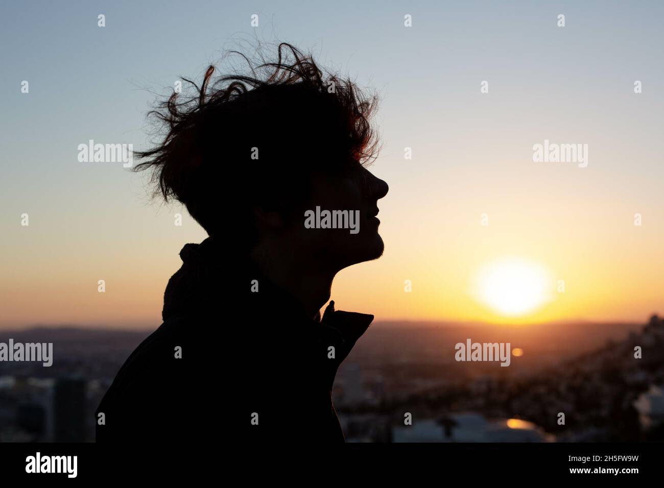 Side portrait silhouette of a female against the sunset sky Stock Photo ...
