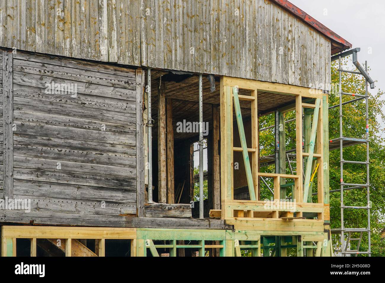reconstruction of an old wooden house with replacement of some ...