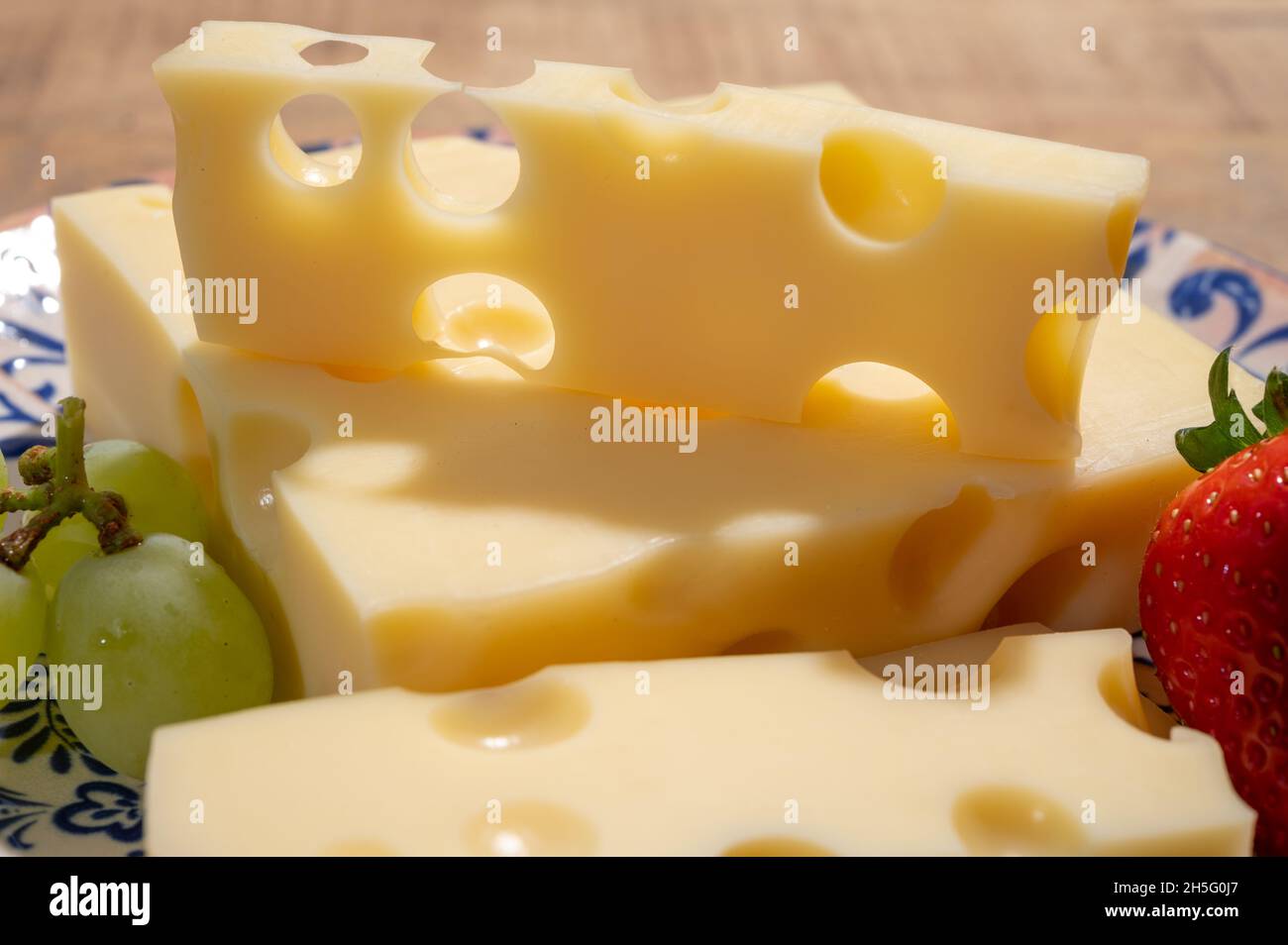 Cheese collection, blocks of French emmentaler cheese with many round ...