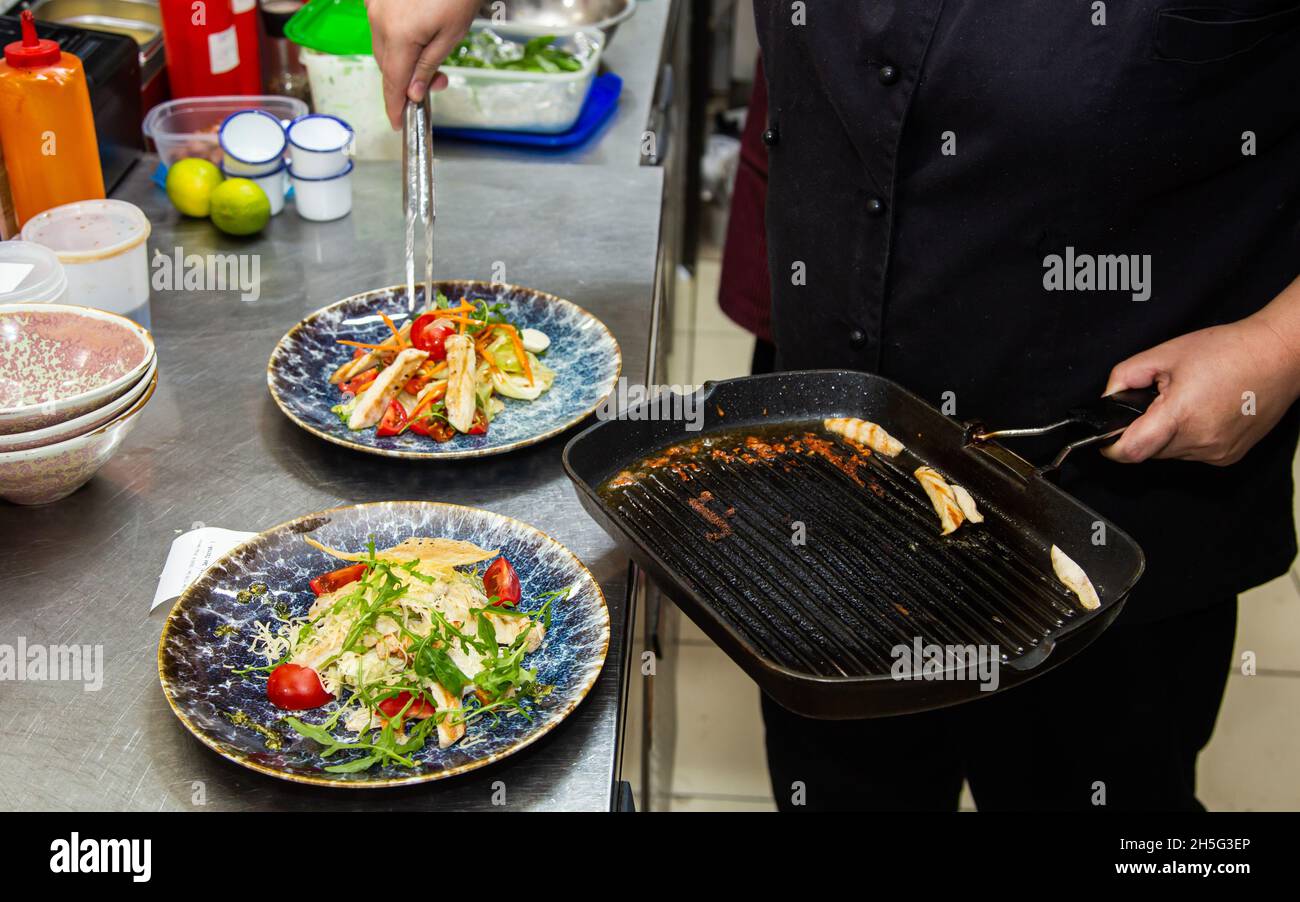 Professional chef cooking in the kitchen restaurant at the hotel ...