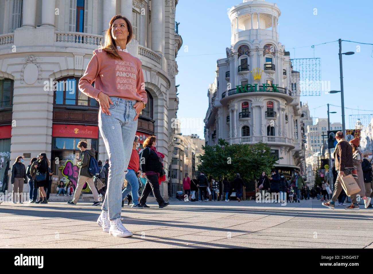 Woman in jeans posing on Gran Via in Madrid Stock Photo - Alamy