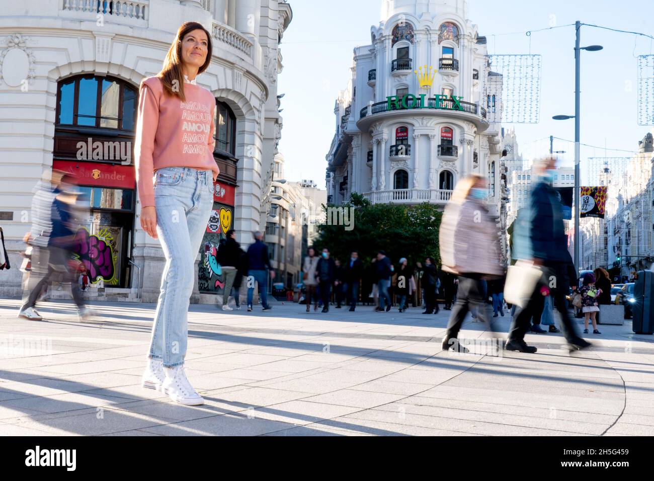 Woman in jeans posing on Gran Via in Madrid Stock Photo - Alamy
