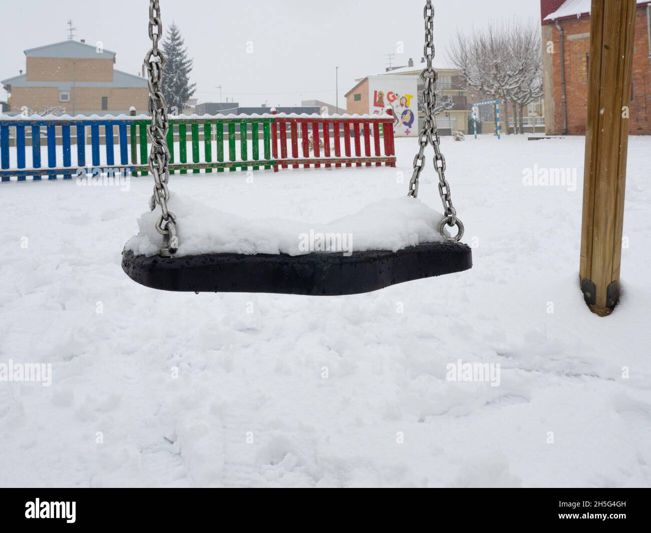 Swing seat covered with snow, winter Stock Photo - Alamy