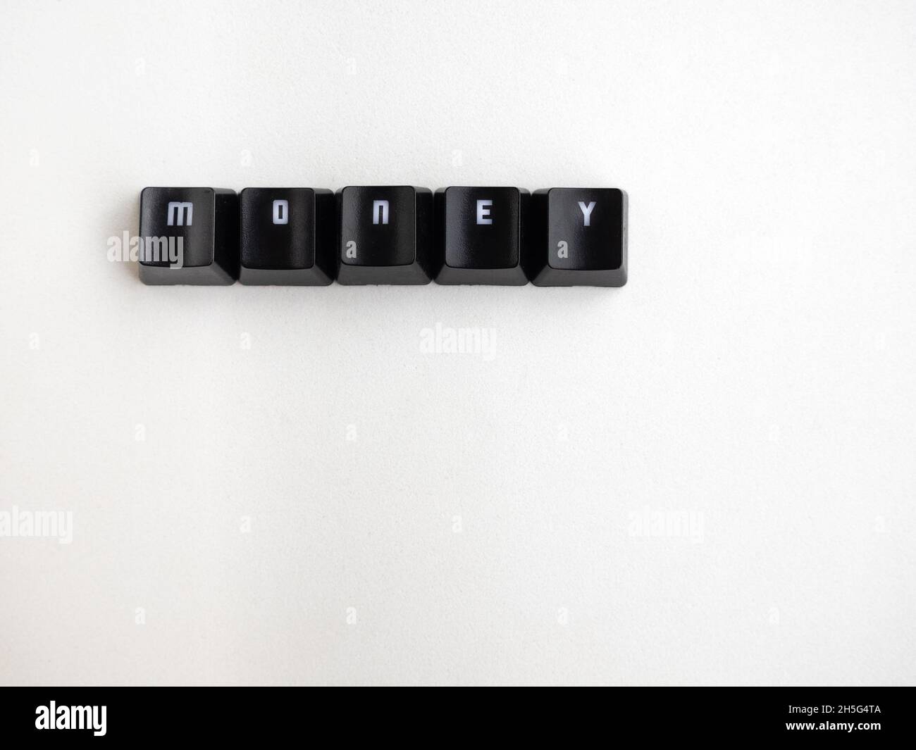 Keys with the word money with white background Stock Photo - Alamy
