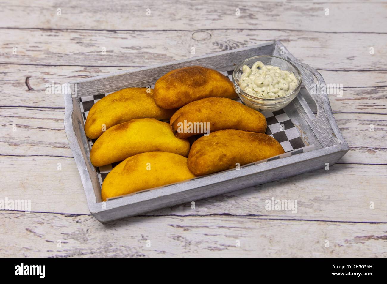 Assortment of Venezuelan chicken empanadas on a wooden table Stock ...