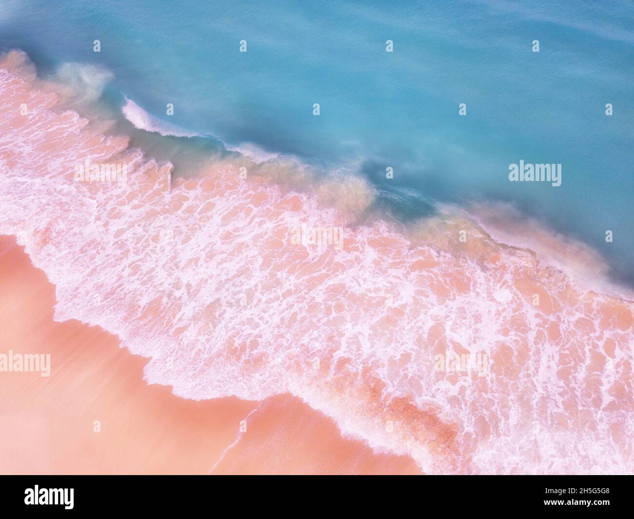 Bird-eye view of the wave hitting the beach Stock Photo - Alamy