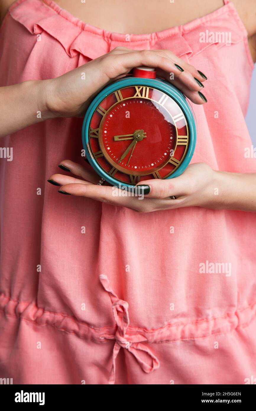 girl with a rare clock in her hands, alarm clock, time concept Stock ...