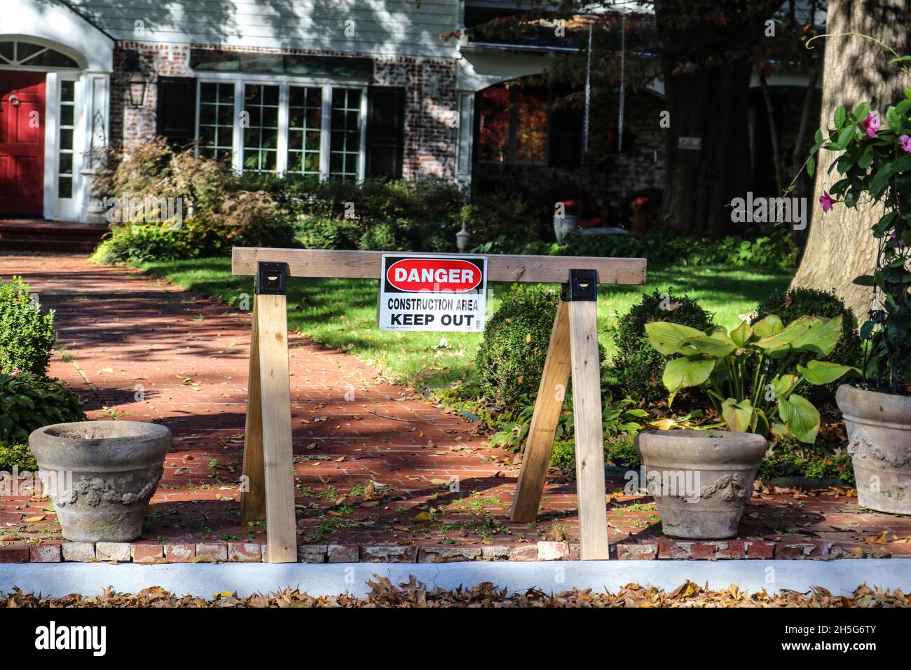 Danger Construction Keep Out sign on driveway of pretty landscaped ...