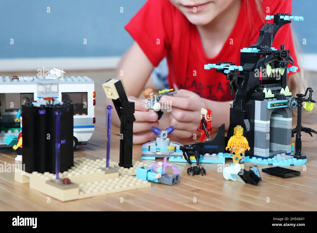 Child creating their own imaginary world with Lego blocks Stock Photo ...