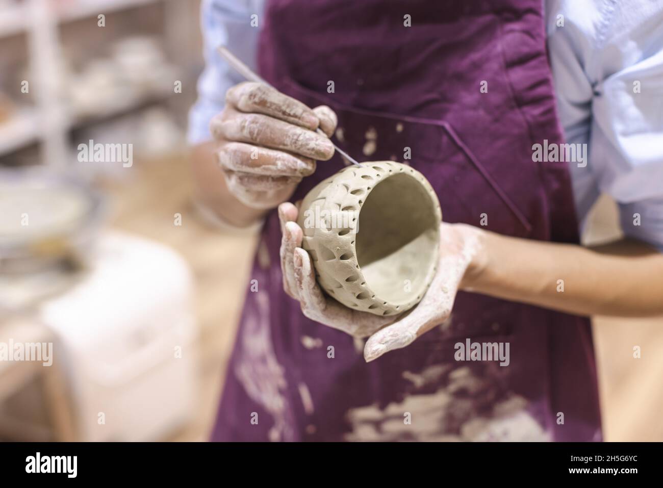 Female pottery artist working on clay bowl. Creative handmade craft ...