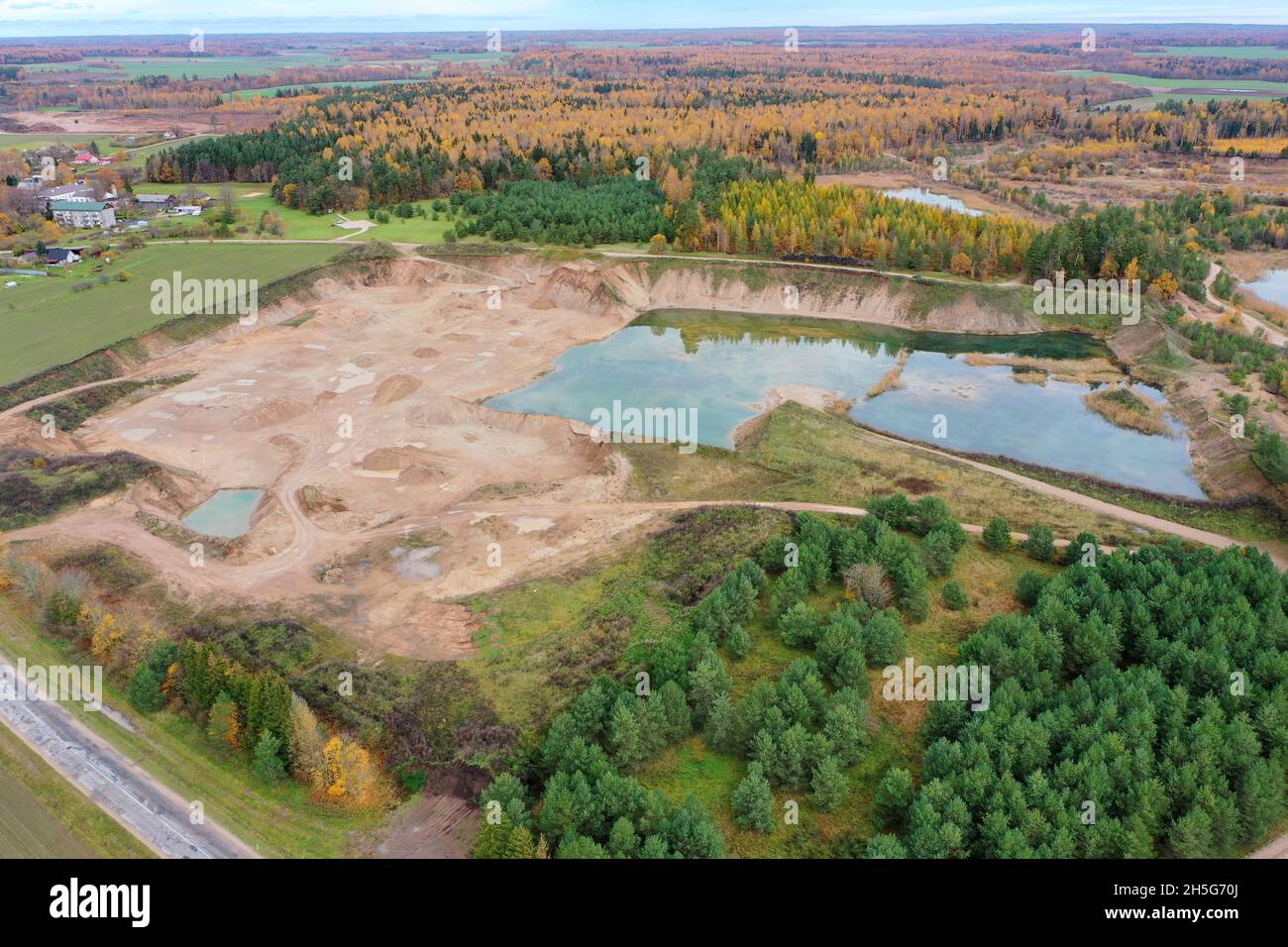 Aerial view of an opencast sand, gravel mine quarry full with green ...