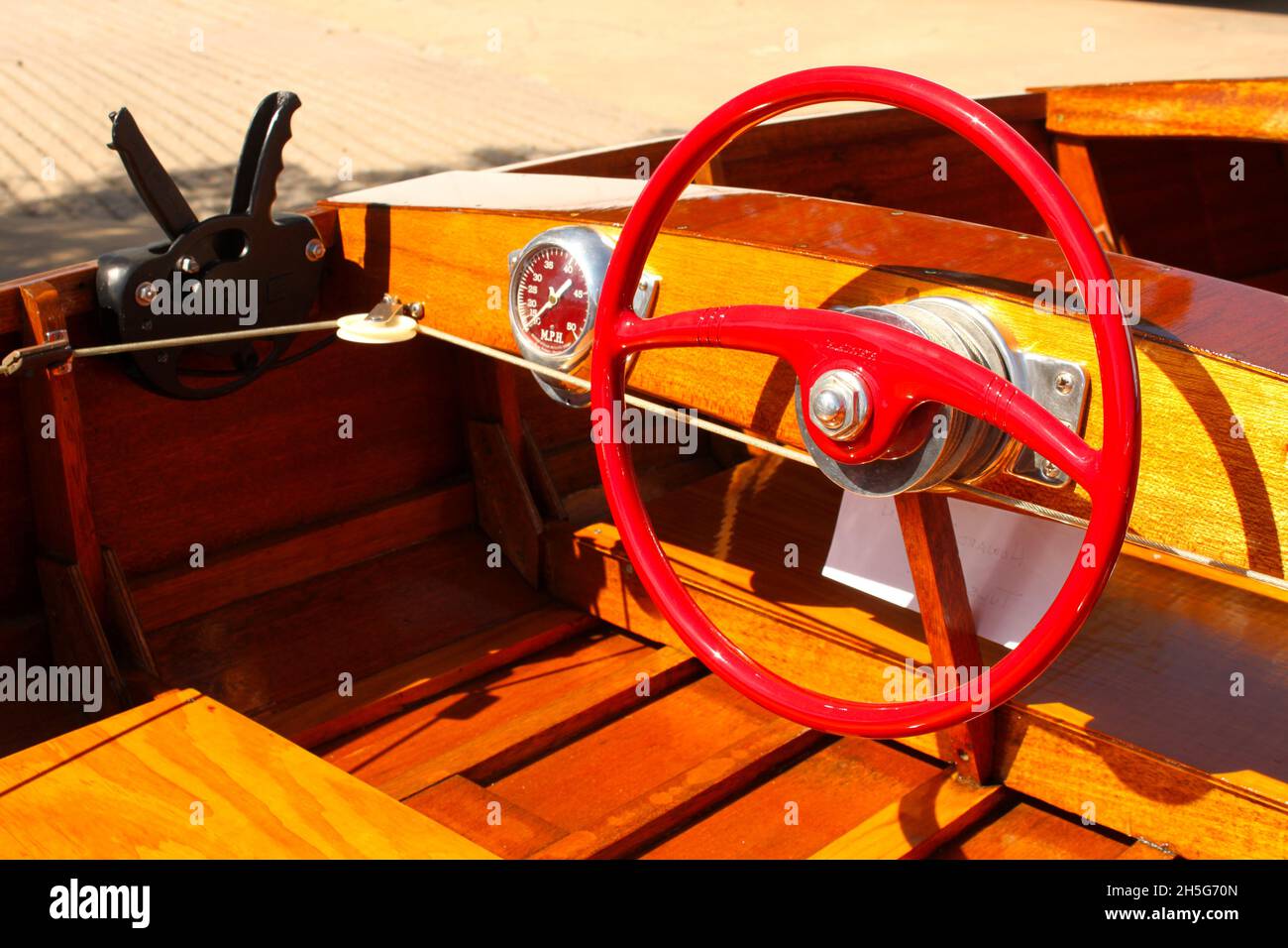 Detail of Wood Speed Boat with Bright Red Steering Wheel at Dock with ...