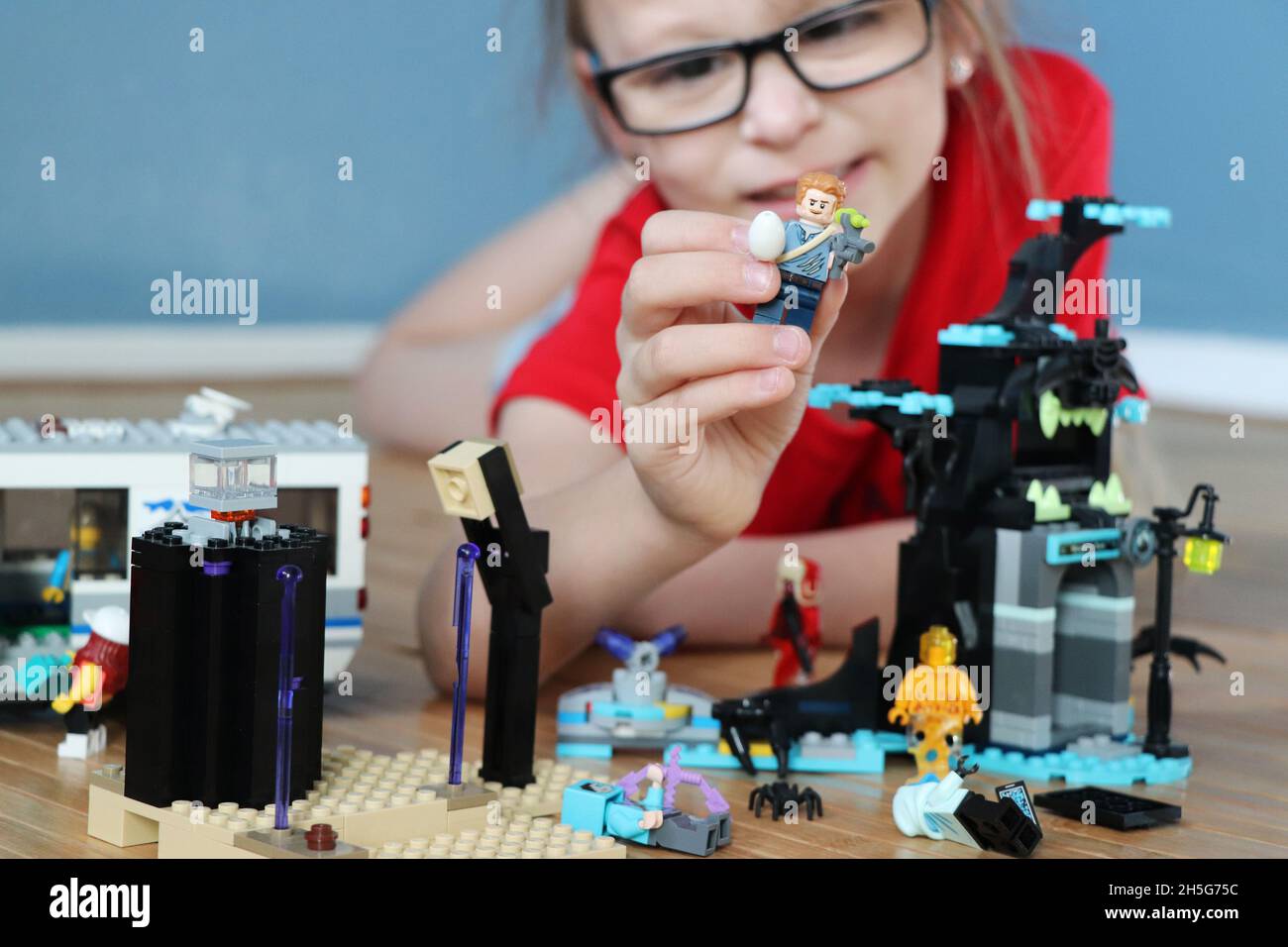 Child creating their own imaginary world with Lego blocks Stock Photo ...
