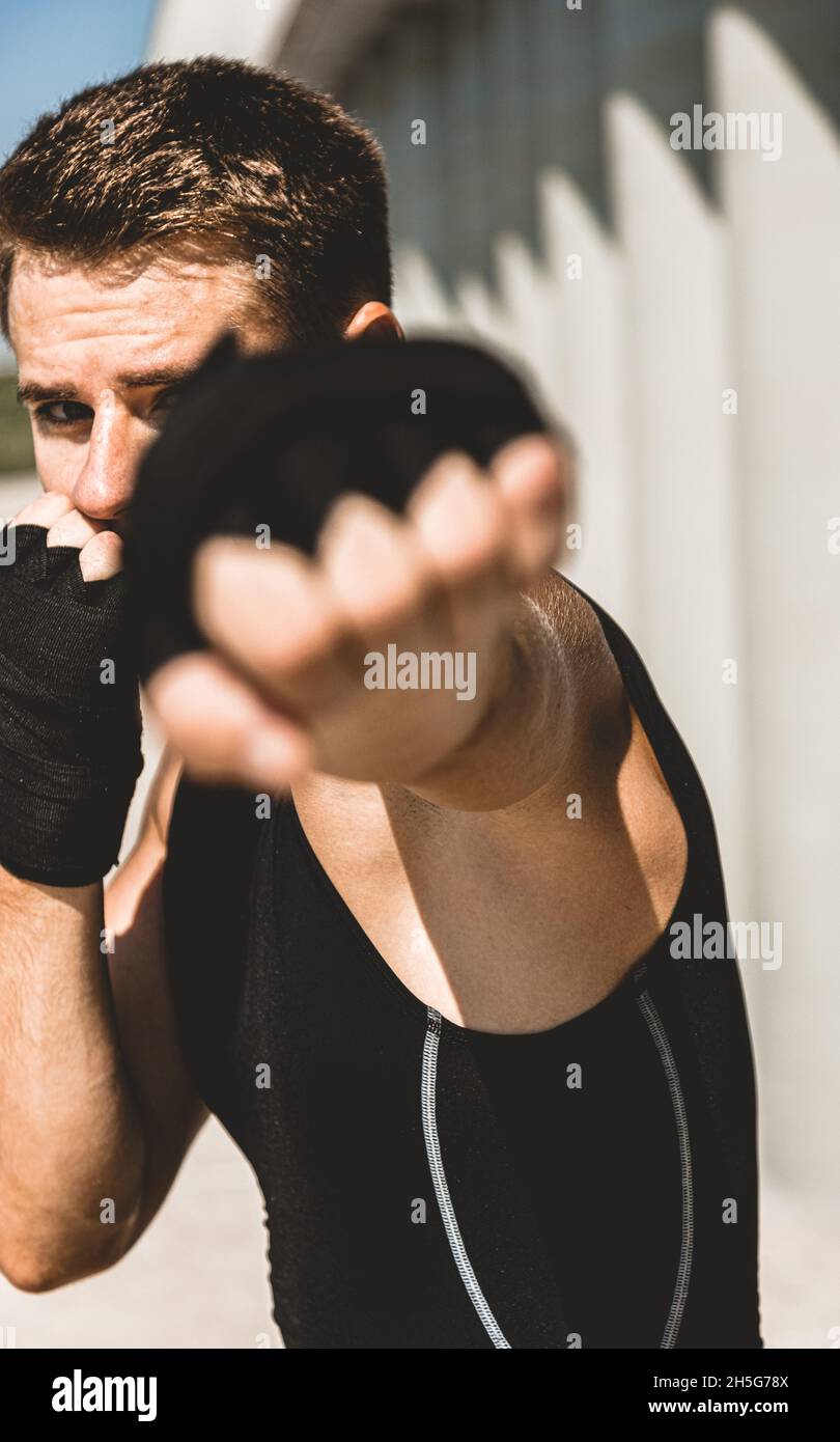 Man exercising and fighting in outside, boxer in gloves. male boxer ...