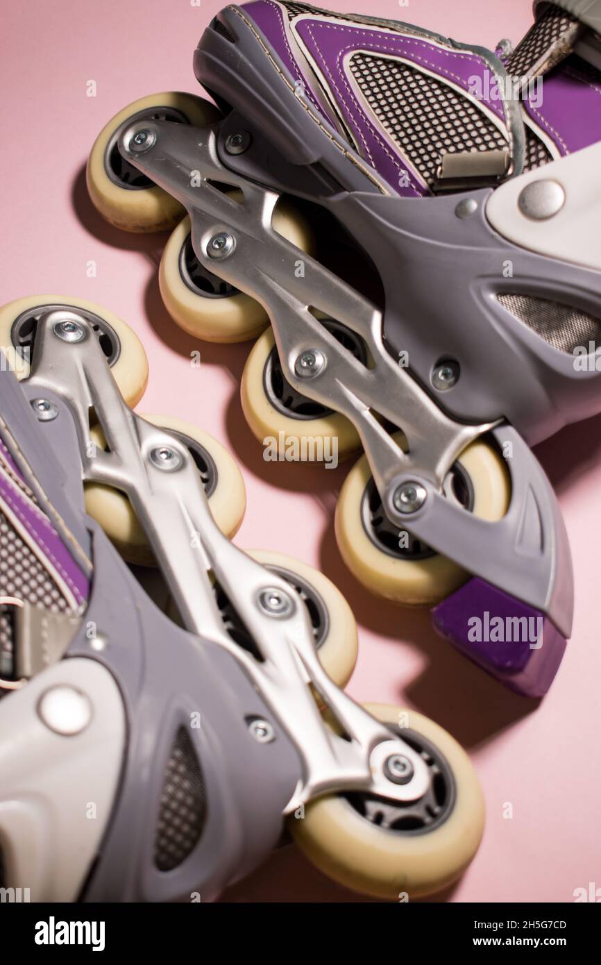 Purple line skates on a bright pink surface with copy space Stock Photo ...
