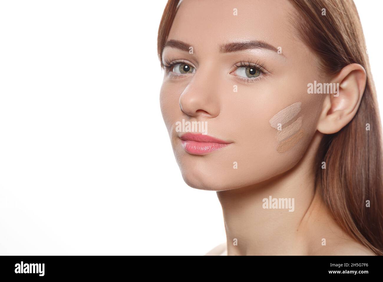 close-up portrait of a young girl who chooses a shade of foundation as ...