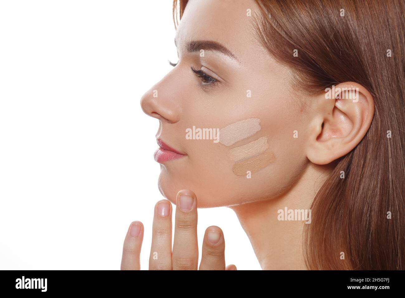 close-up portrait of a young girl who chooses a shade of foundation as ...