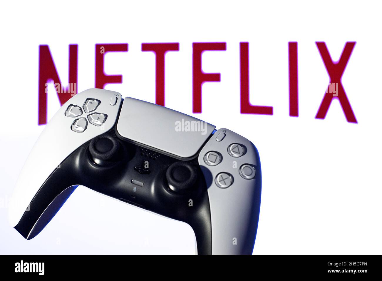 In this photo illustration, a PlayStation 5 controller seen with a ...