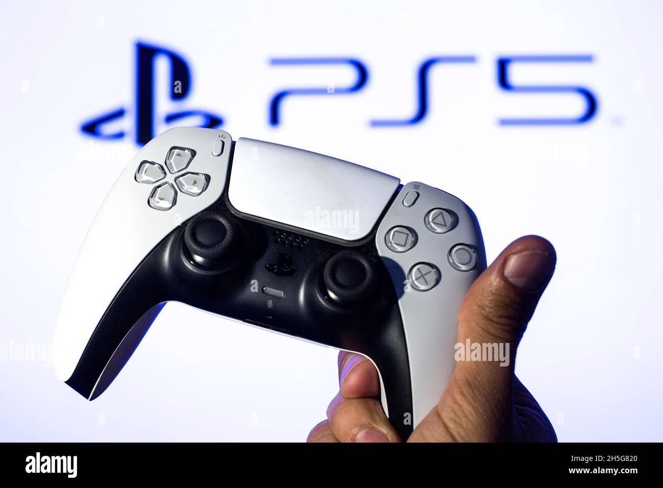 In this photo illustration, a PlayStation 5 controller seen with a ...