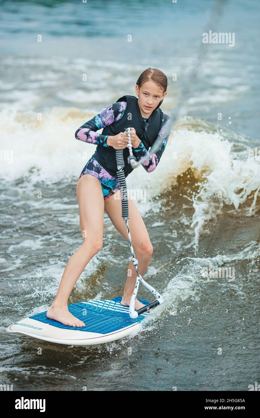 Active Beautiful Girl In The Swimsuit Standing On The Wakeboard In The