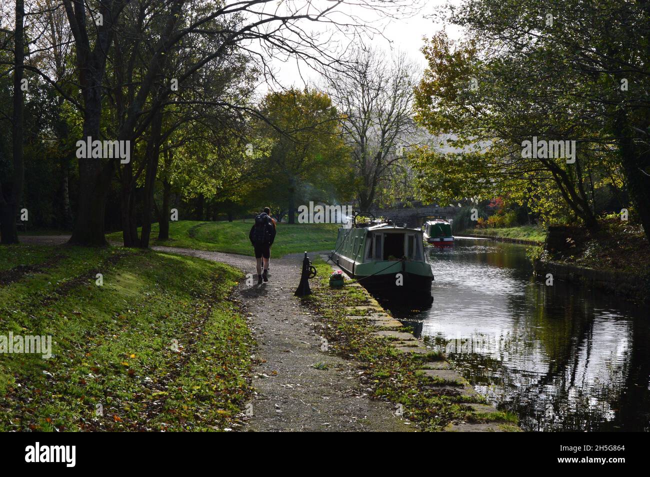 Man walking alongside canal Stock Photo - Alamy