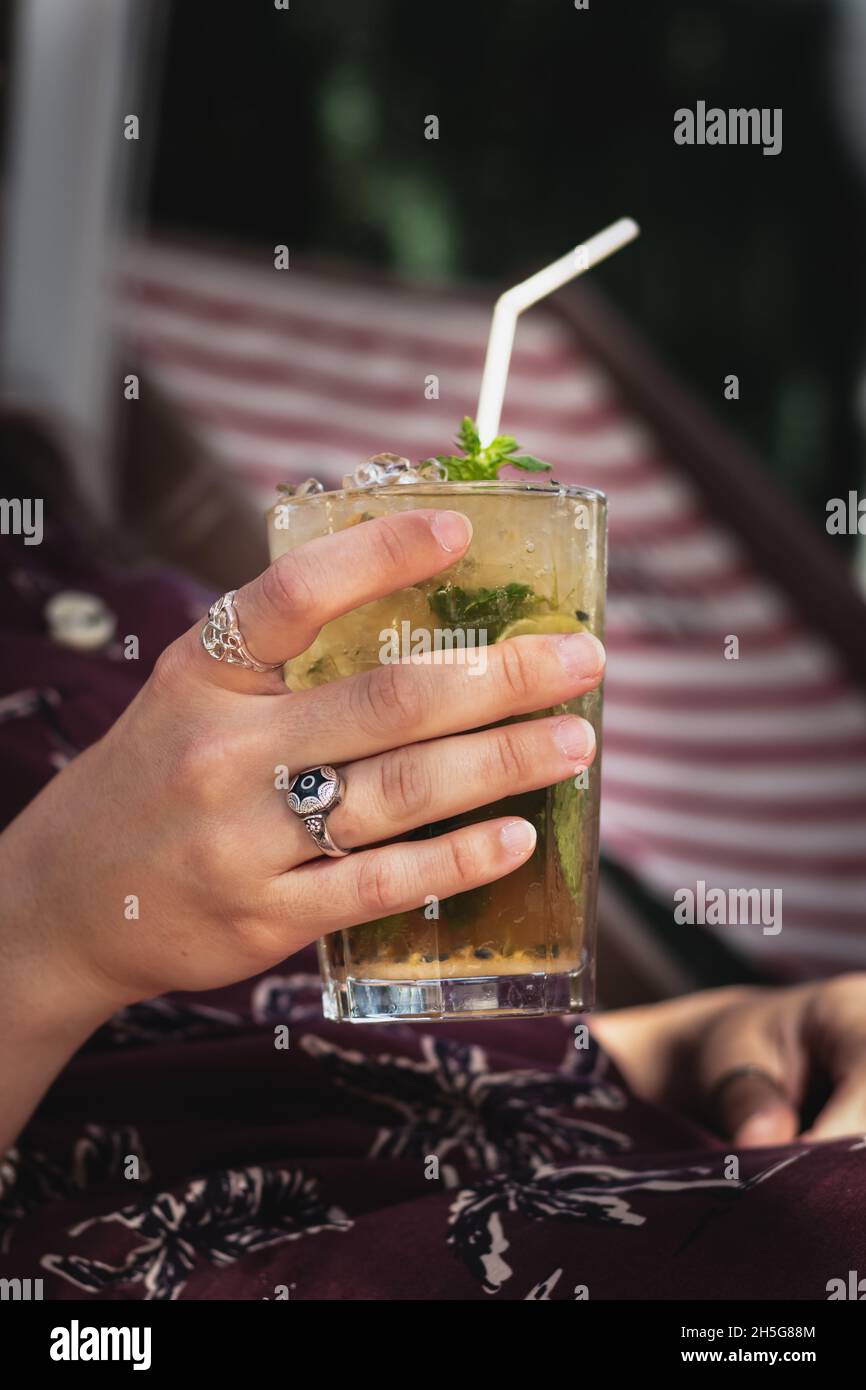 Selective of a glass of mojito in a hand of a female Stock Photo - Alamy