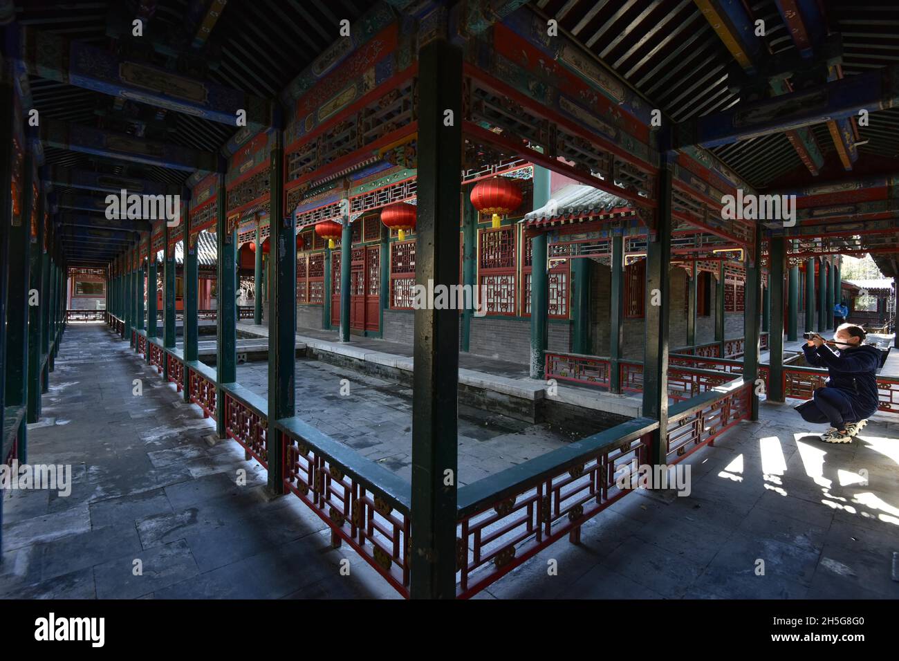 A man is seen taking a photo on the balcony of Prince Gong's Manson ...
