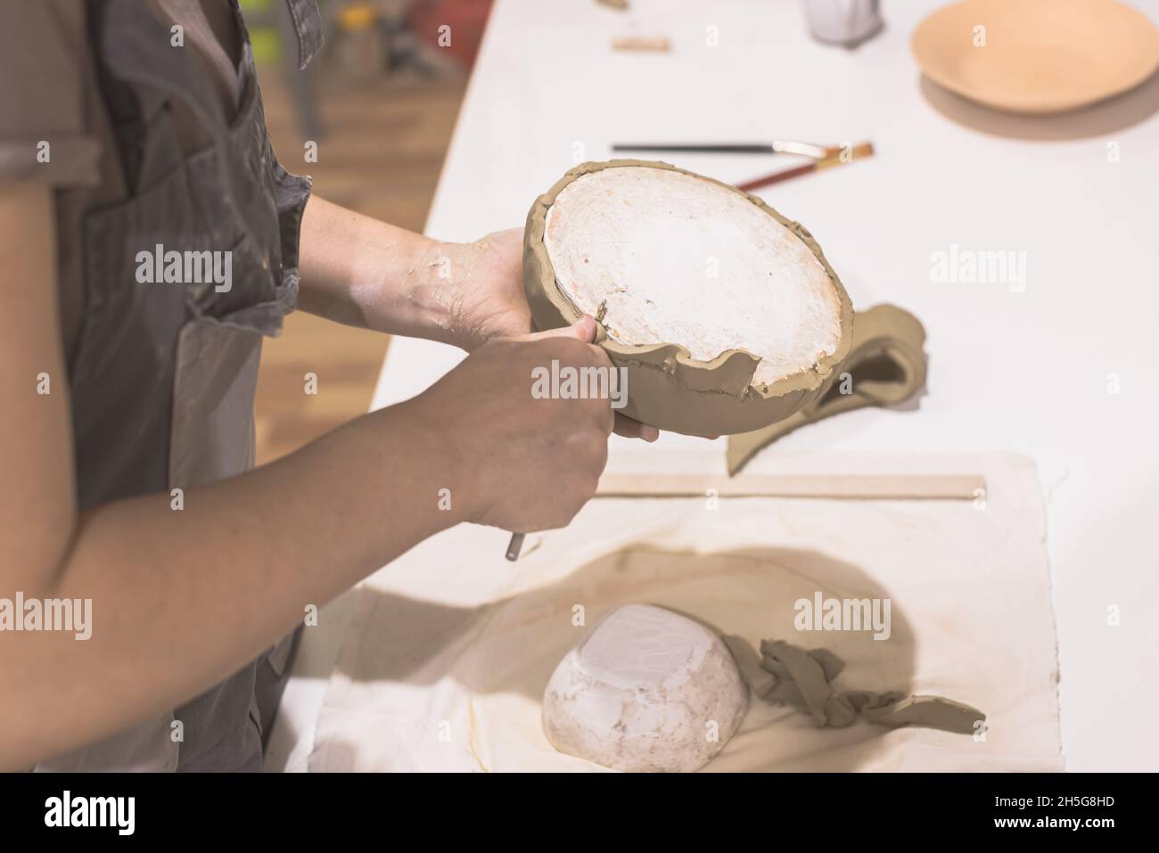 Female pottery artist preparing clay for molding. Close Up view of ...