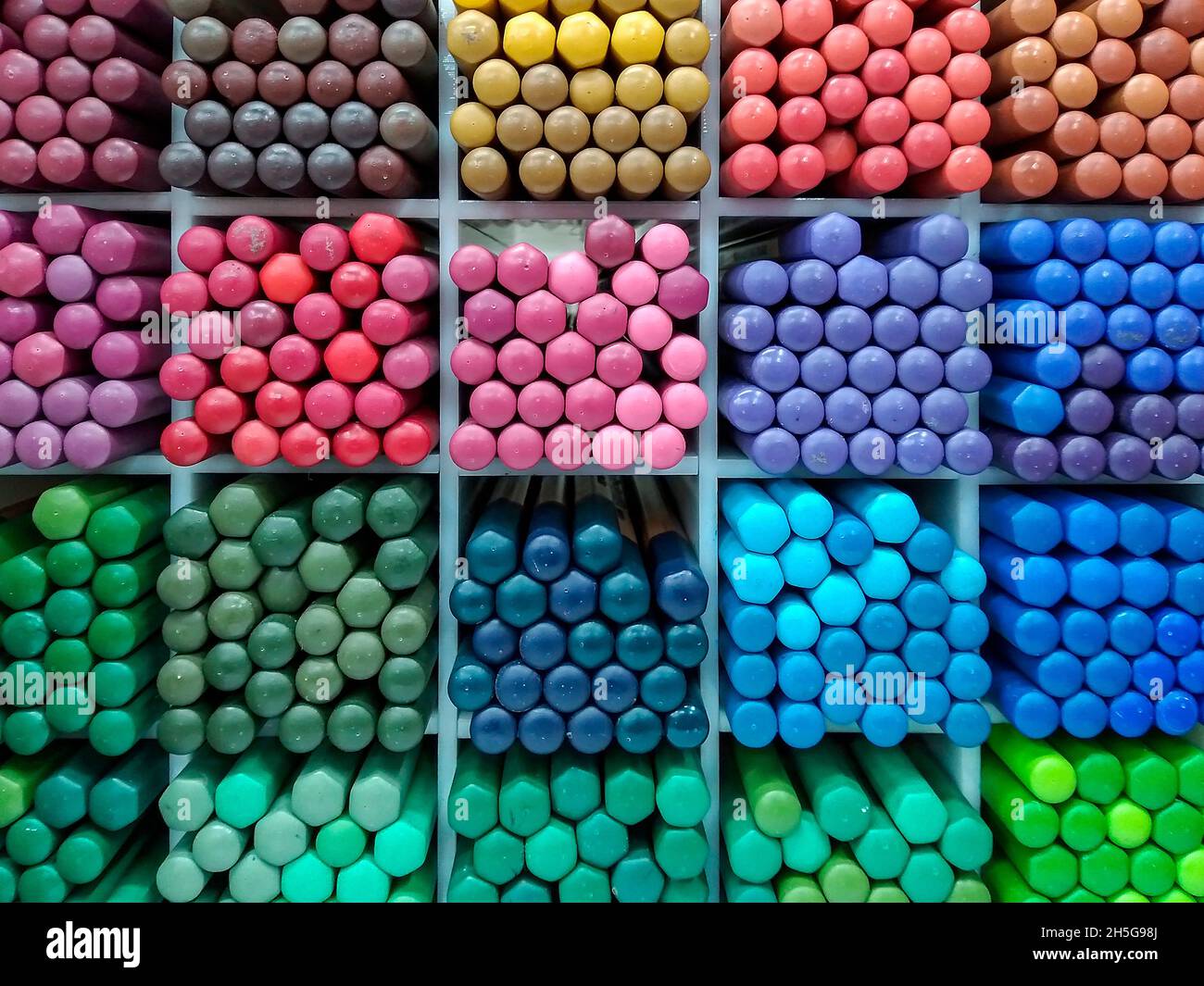 Multicolored pens and pencils on shelves in a shop. Office supplies and ...